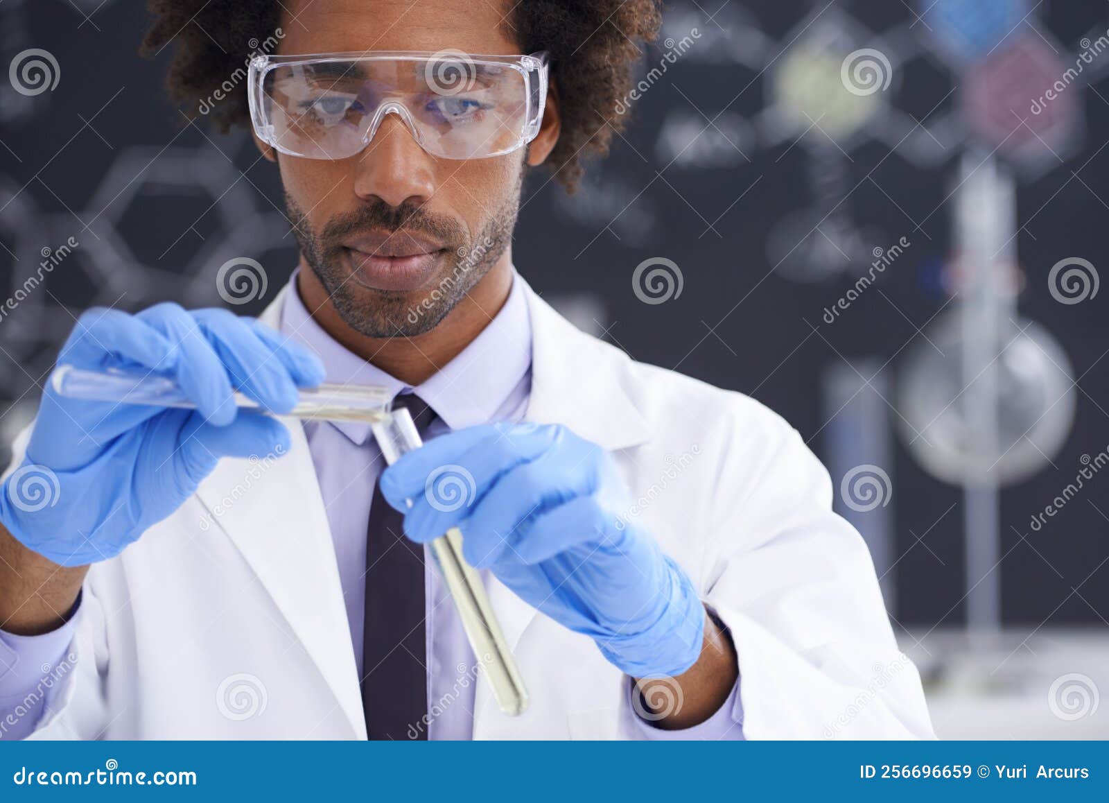 Experiments in Progress. a Male Scientist Conducting an Experiment in ...