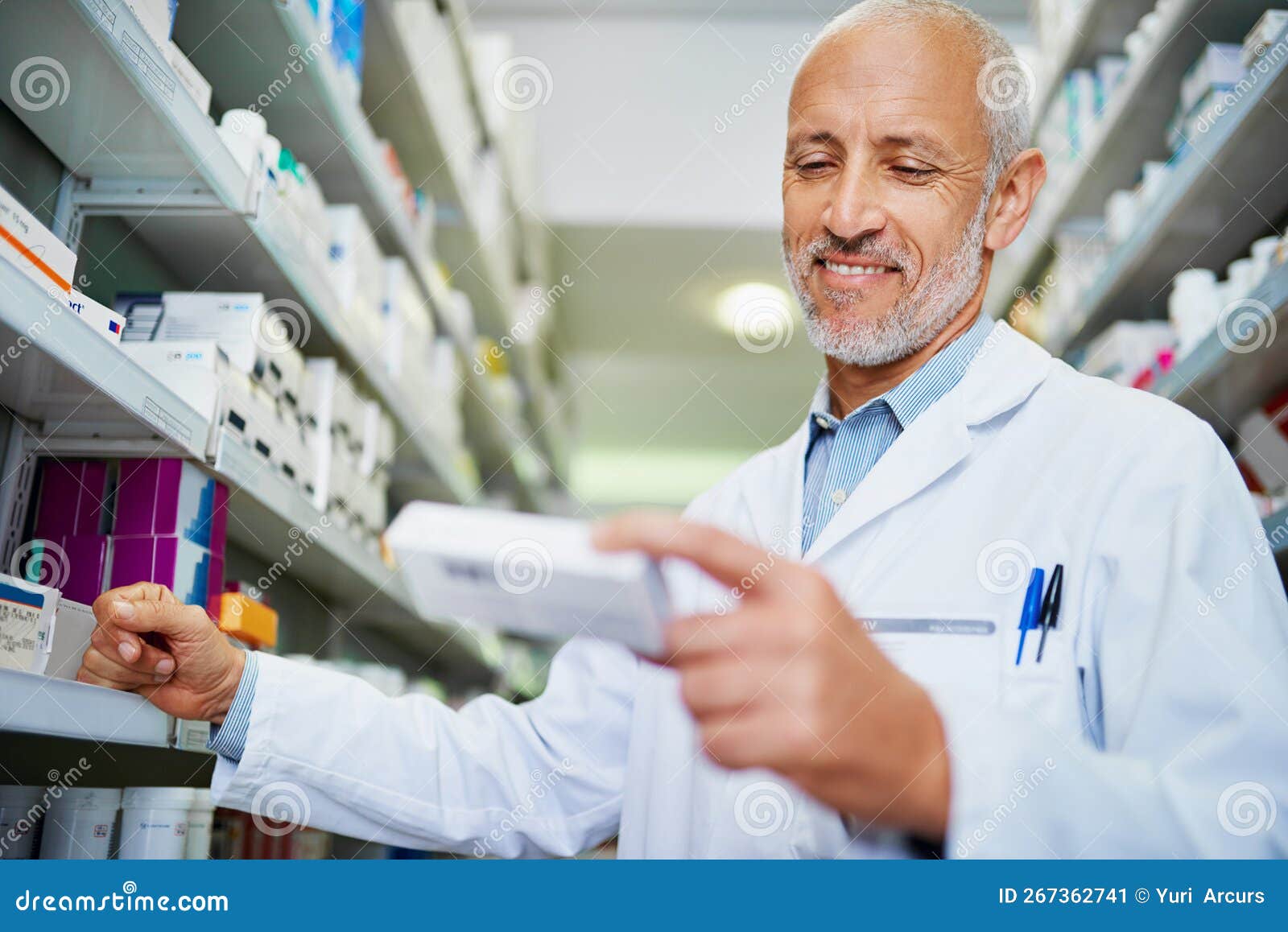 The Expert in All Things Medicinal. a Mature Pharmacist Doing Inventory ...