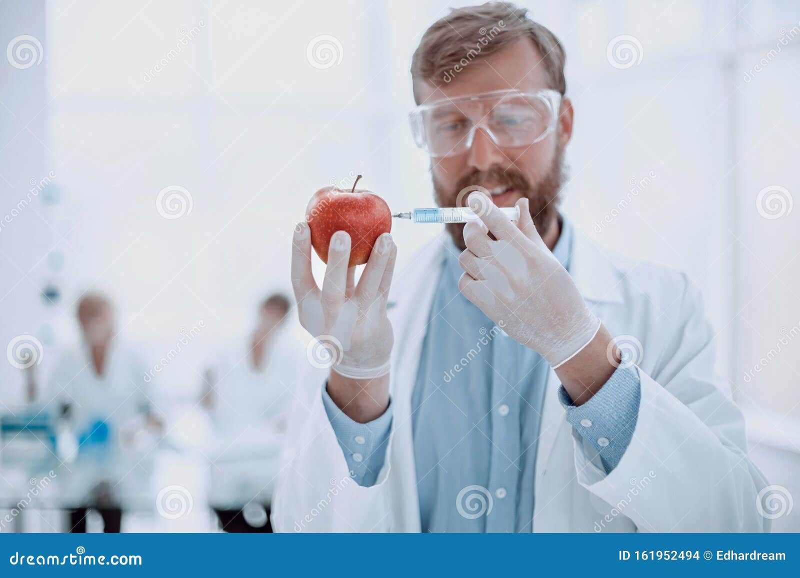 Expert with Apple and Syringe Standing in the Laboratory Stock Photo ...