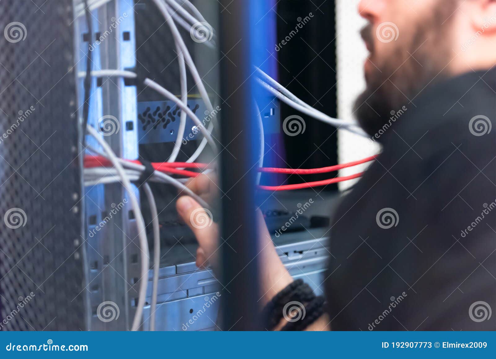 An Expert Engeneer in Datacenter Server Room Connecting Cables in ...
