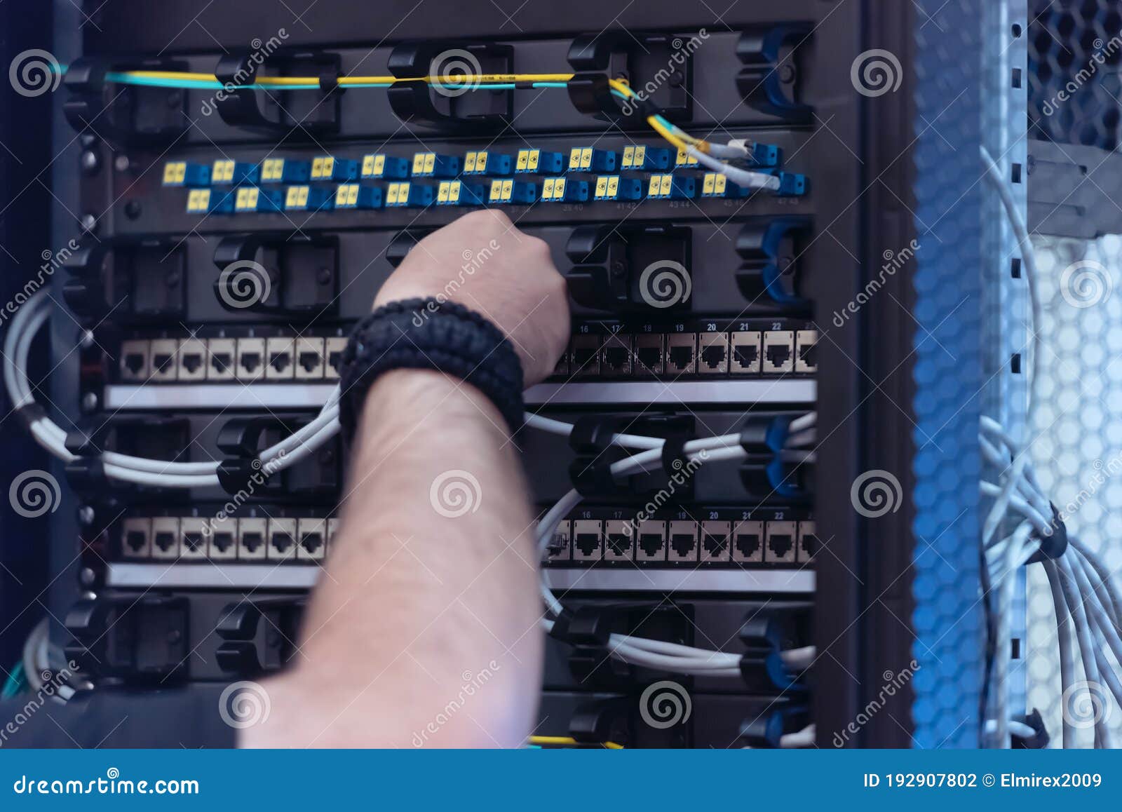 An Expert Engeneer in Datacenter Server Room Connecting Cables in ...
