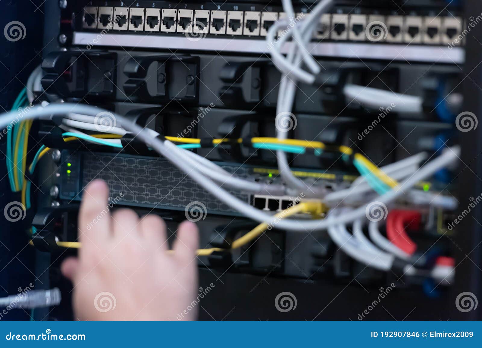 An Expert Engeneer in Datacenter Server Room Connecting Cables in ...