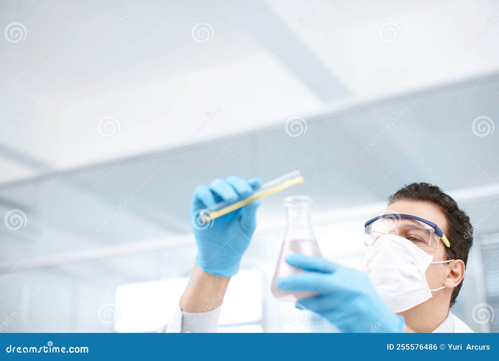 The Expert at Mixing Chemicals. Low Angle Shot of a Chemist Mixing ...