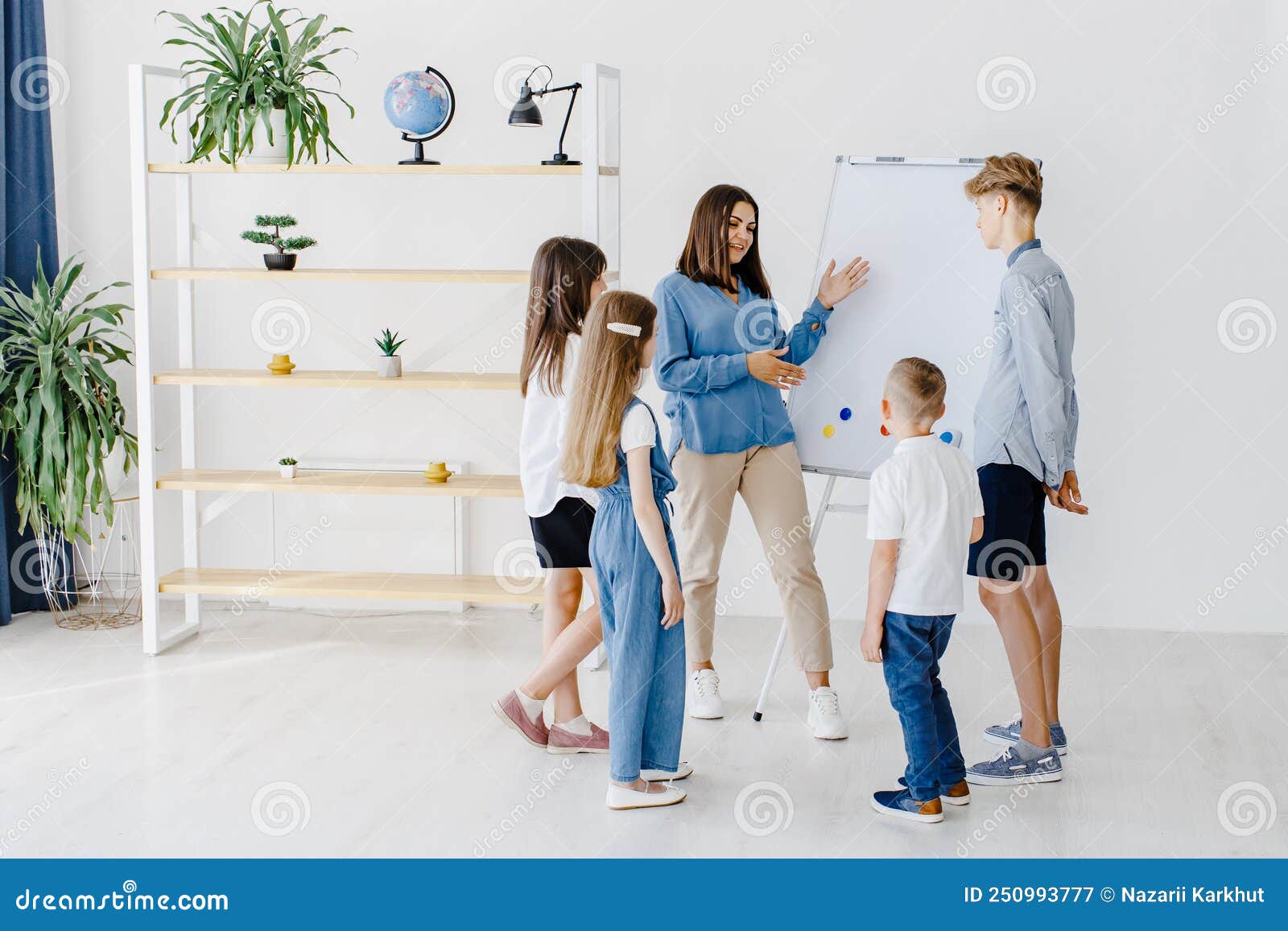 Explaining Lesson and Using Board. Group of Children Students of ...