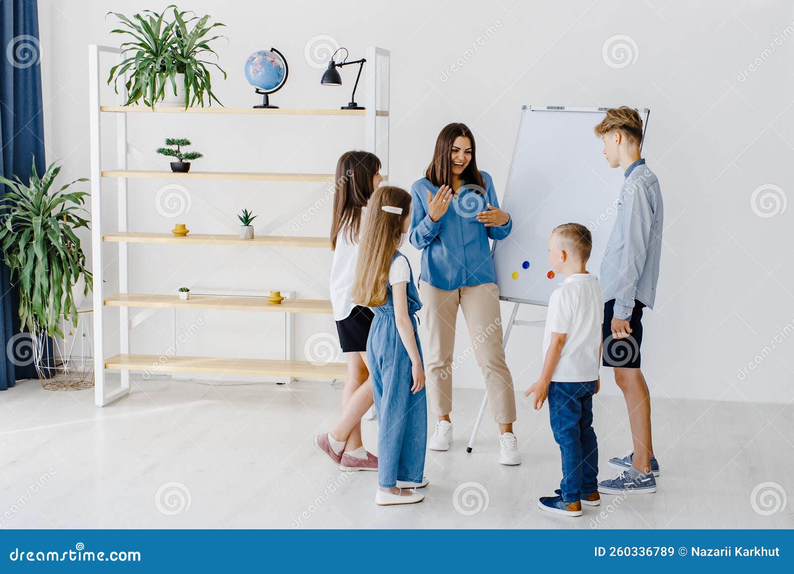 Explaining Lesson and Using Board. Group of Children Students of ...