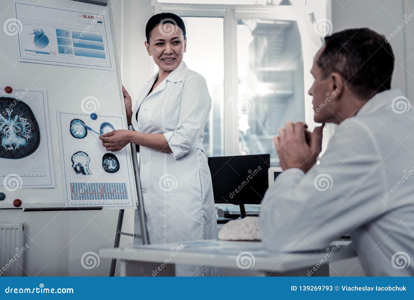 Scientist Explaining the Processes in Brain To Her Colleague Stock ...