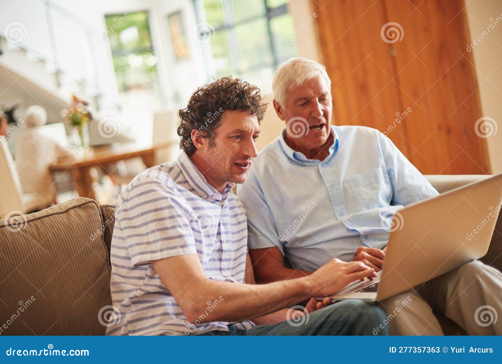 Explaining Technology Basics To His Dad. a Man and His Father Using a ...