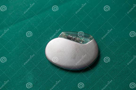 Explanted Pacemaker on a Green Surgical Drape Stock Image - Image of ...