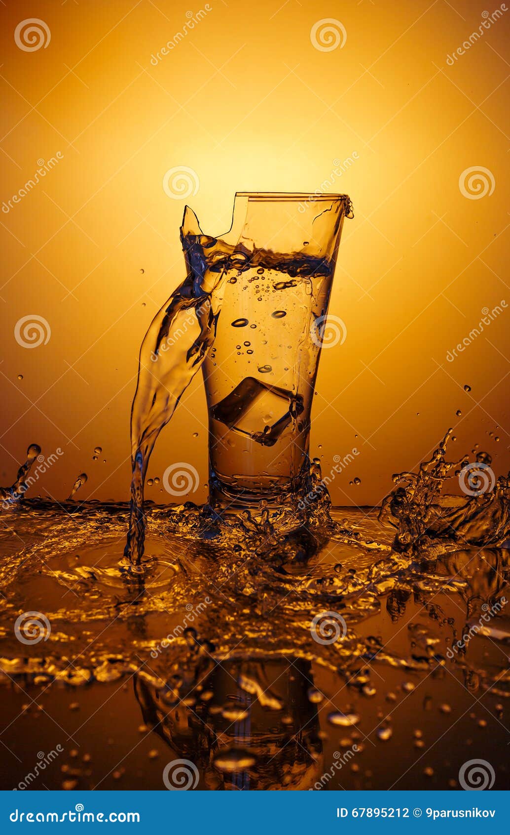 Exploding Glass Cup with Water Shattering Over Orange Background. Stock ...