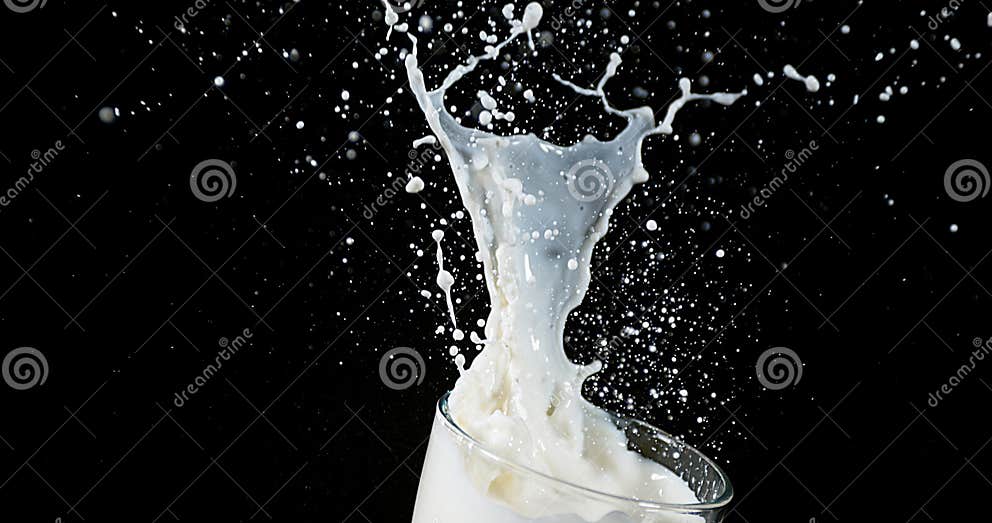 Exploding Milk Against Black Background Stock Photo - Image of ...