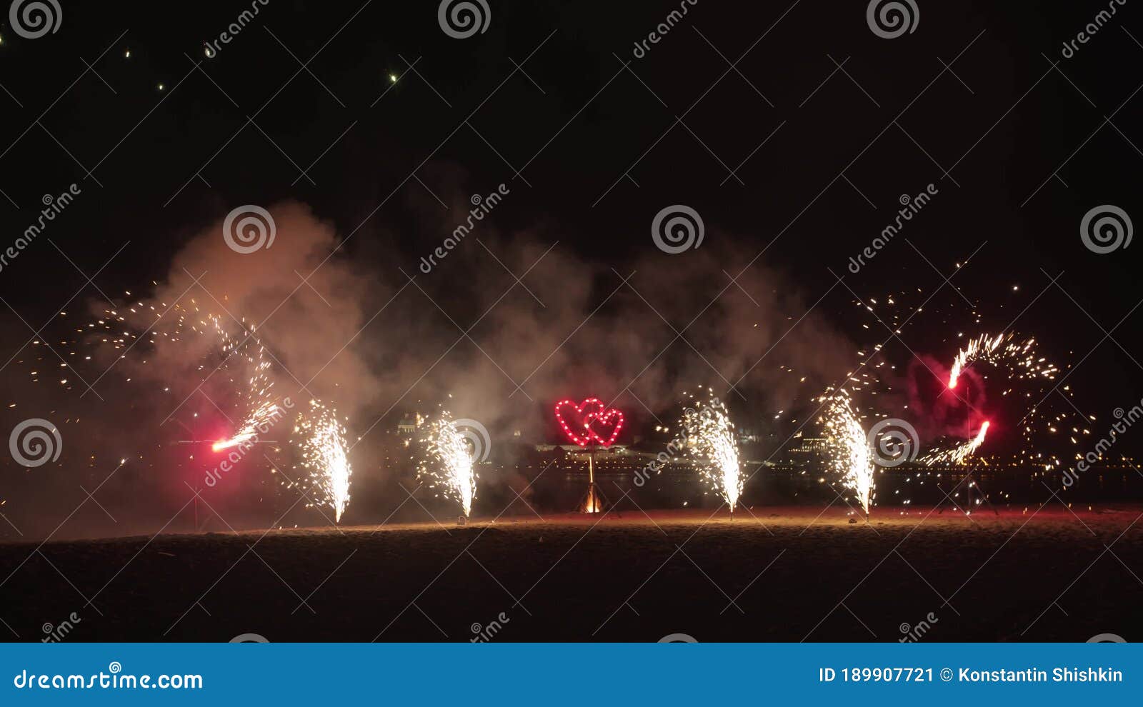 Exploding and Spinning Fireworks on the Beach and Burning Stand in ...
