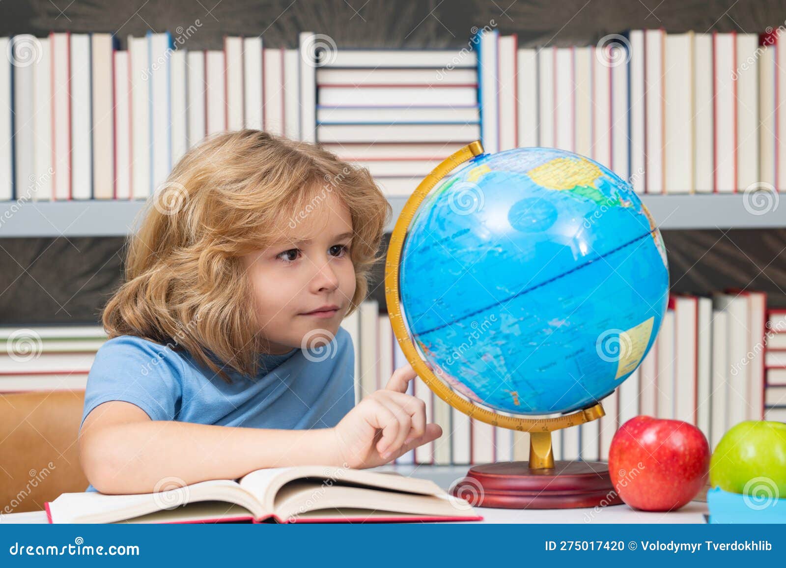 Explorer and Discovery. School Pupil Looking at Globe in Library at the ...