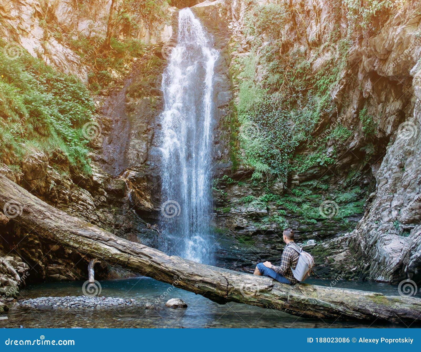 Explorer Young Man Enjoying View of Waterfall in Summer. Stock Photo ...