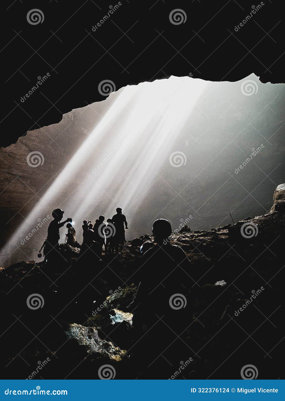 Exploring the Illuminated Cave Passage Stock Photo - Image of night ...