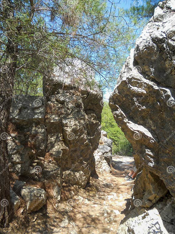 Exploring a Narrow Path between Towering Rocks Stock Image - Image of ...
