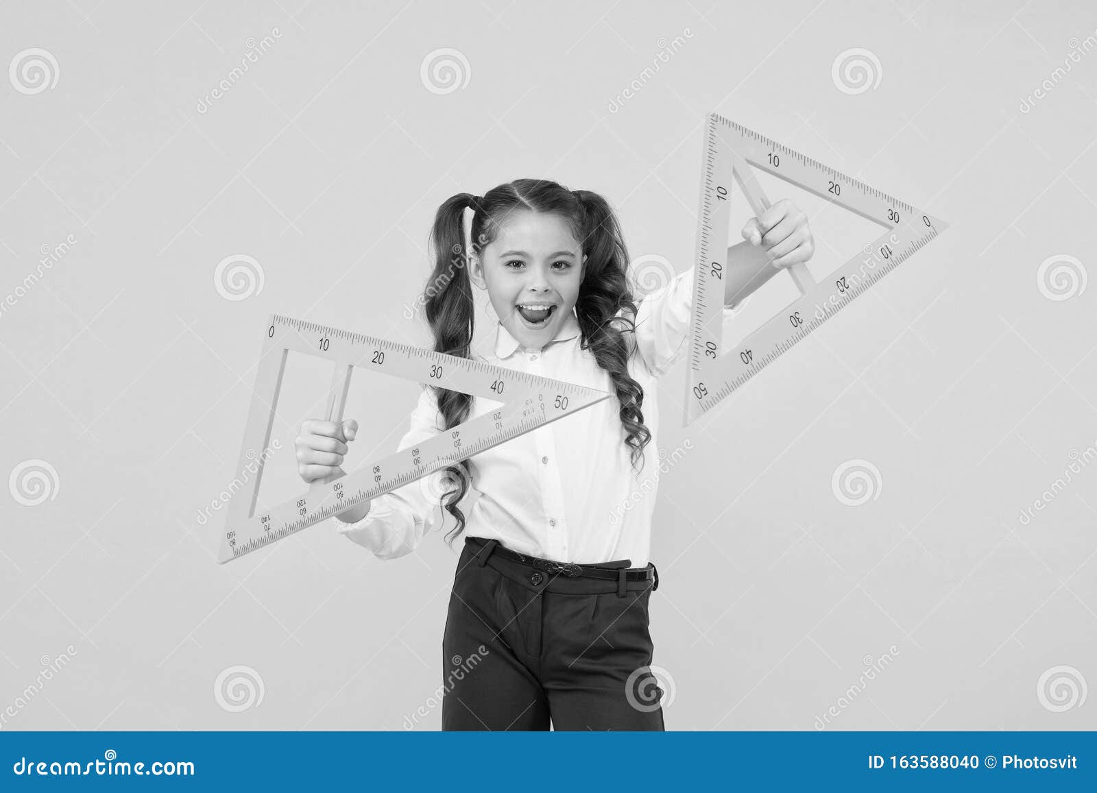 Exploring the Properties of Triangles in the Lesson. Cute Girl Holding ...