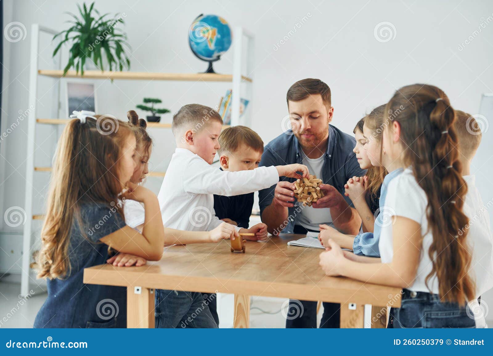 Exploring Puzzle Toy. Group of Children Students in Class at School ...
