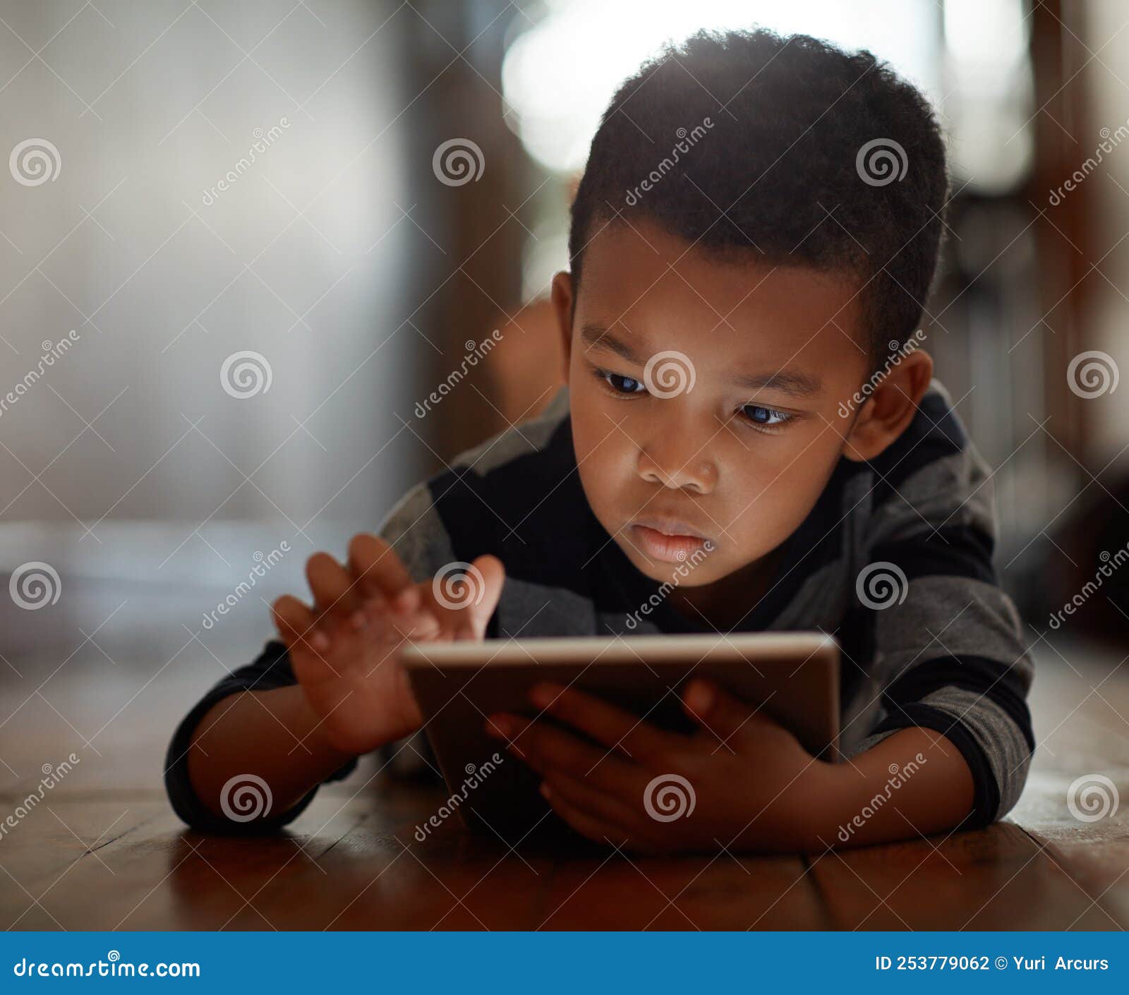 Exploring a World of Apps. a Young Boy Using His Digital Tablet while ...