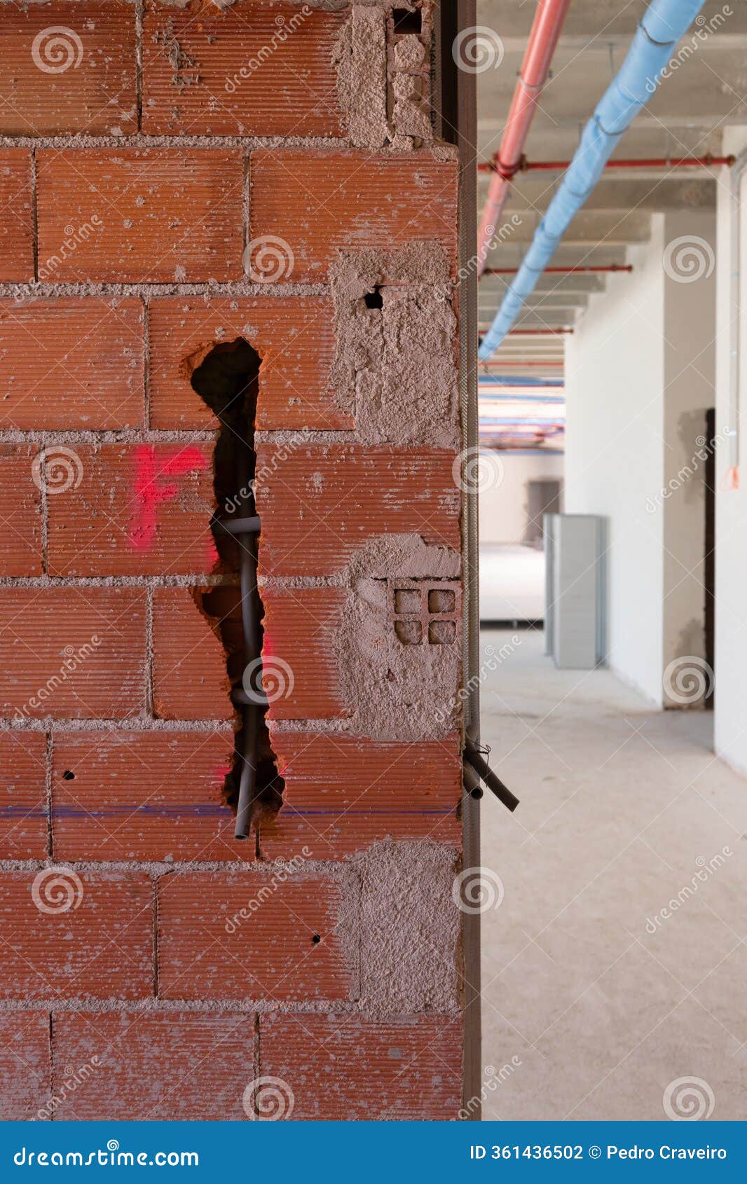 Exposed Brick Wall with Visible Electrical Conduit and Unfinished ...