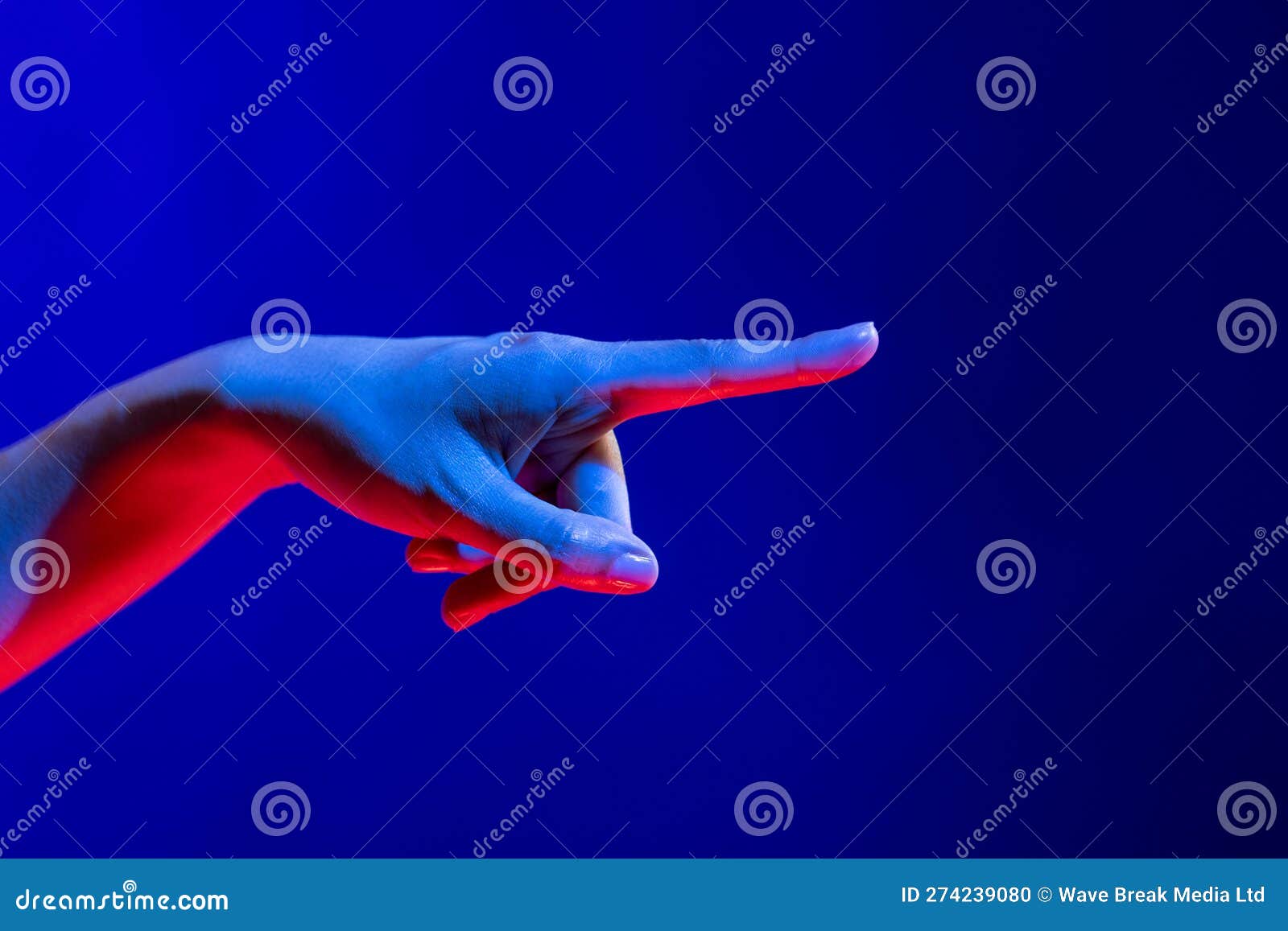 Exposed Hand Pointing Finger in Studio with Blue Light with Copy Space ...