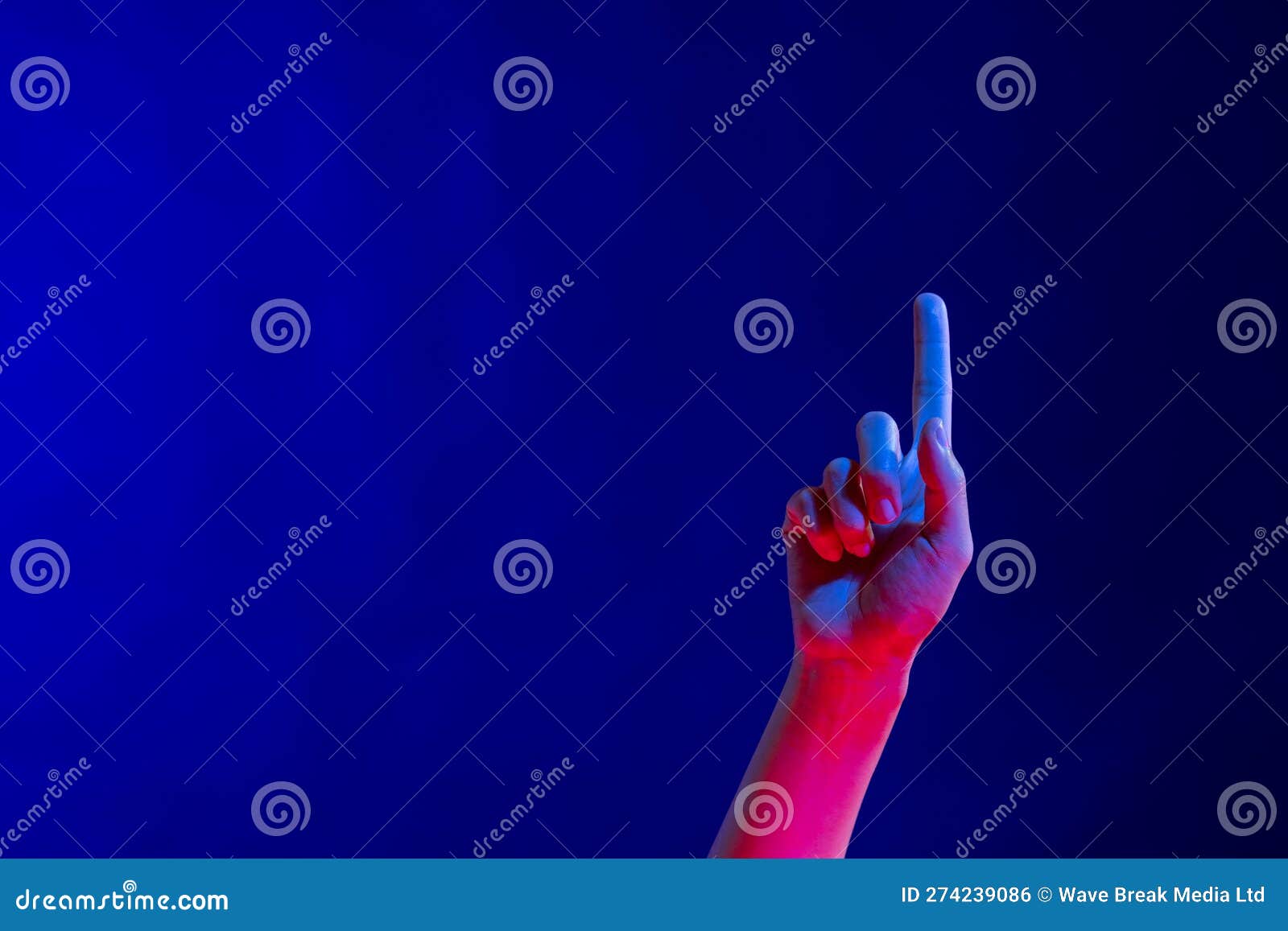 Exposed Hand Pointing Finger in Studio with Blue Light with Copy Space ...