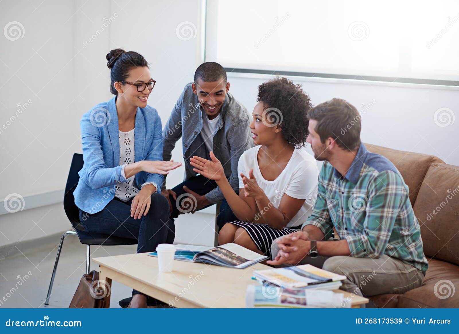 Expressing Ideas. a Group of Designers Having a Meeting Around a Coffee ...