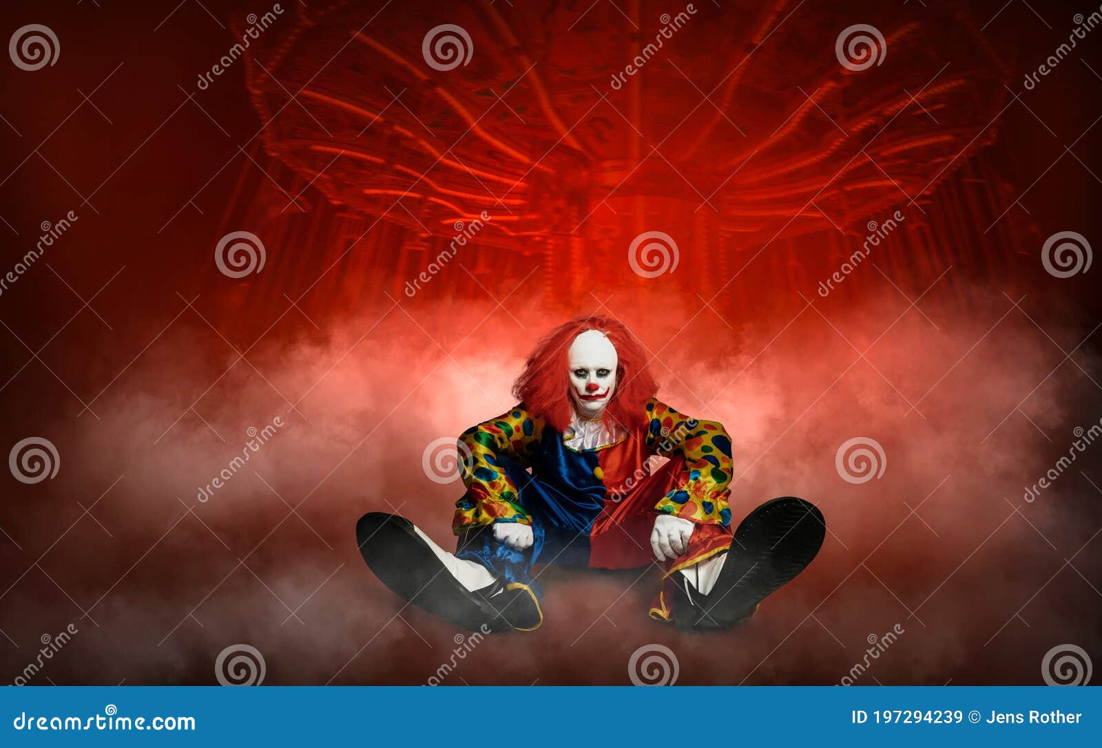 Expressionless Clown Against the Abstract Background of an Amusement ...