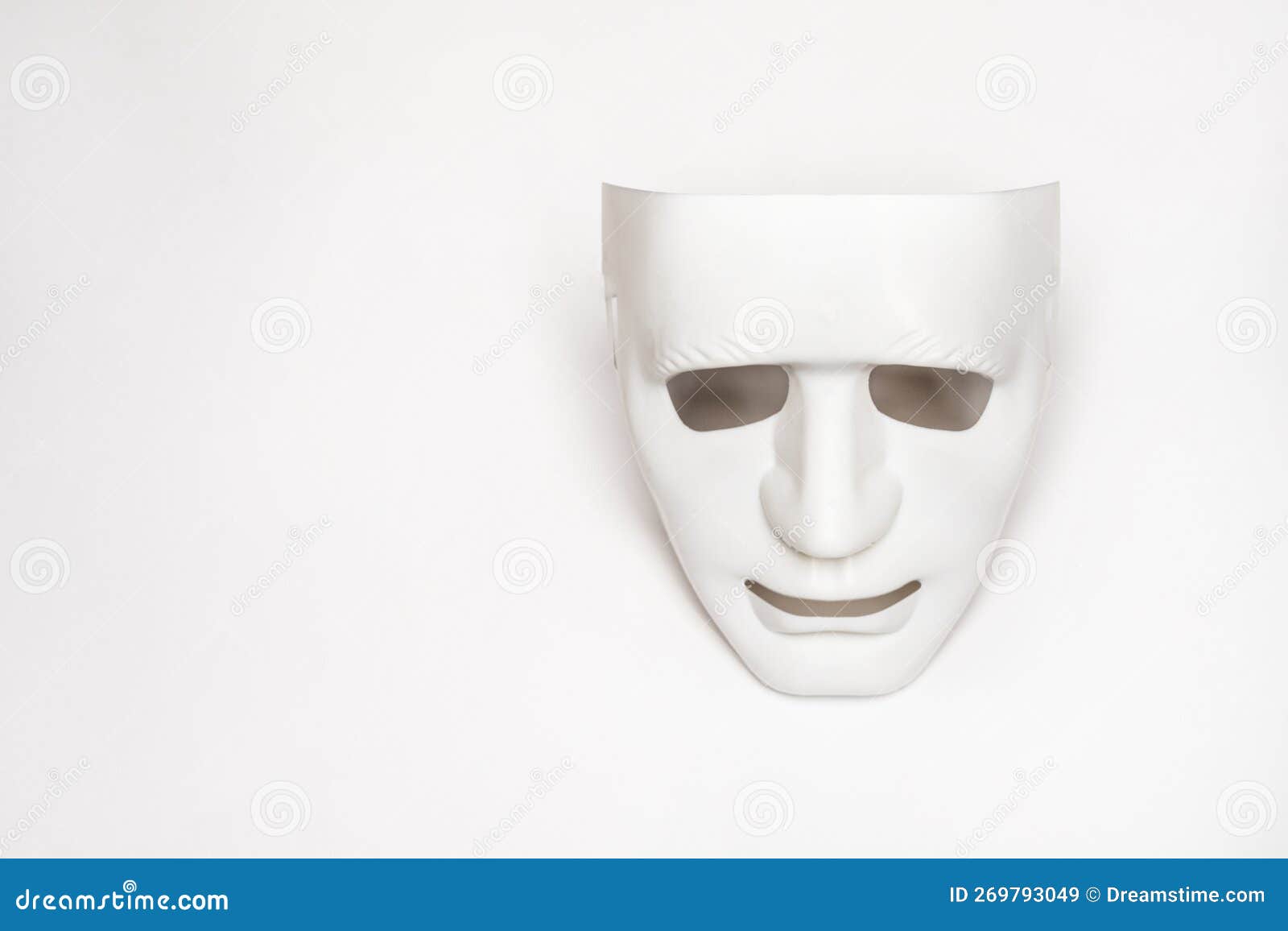 An Expressionless White Masquerade Mask Lying on a Smooth White Surface ...