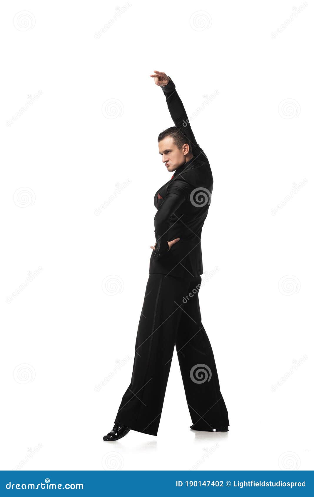 Dancer in Elegant Black Suit Performing Tango with Hand on Hip on White ...