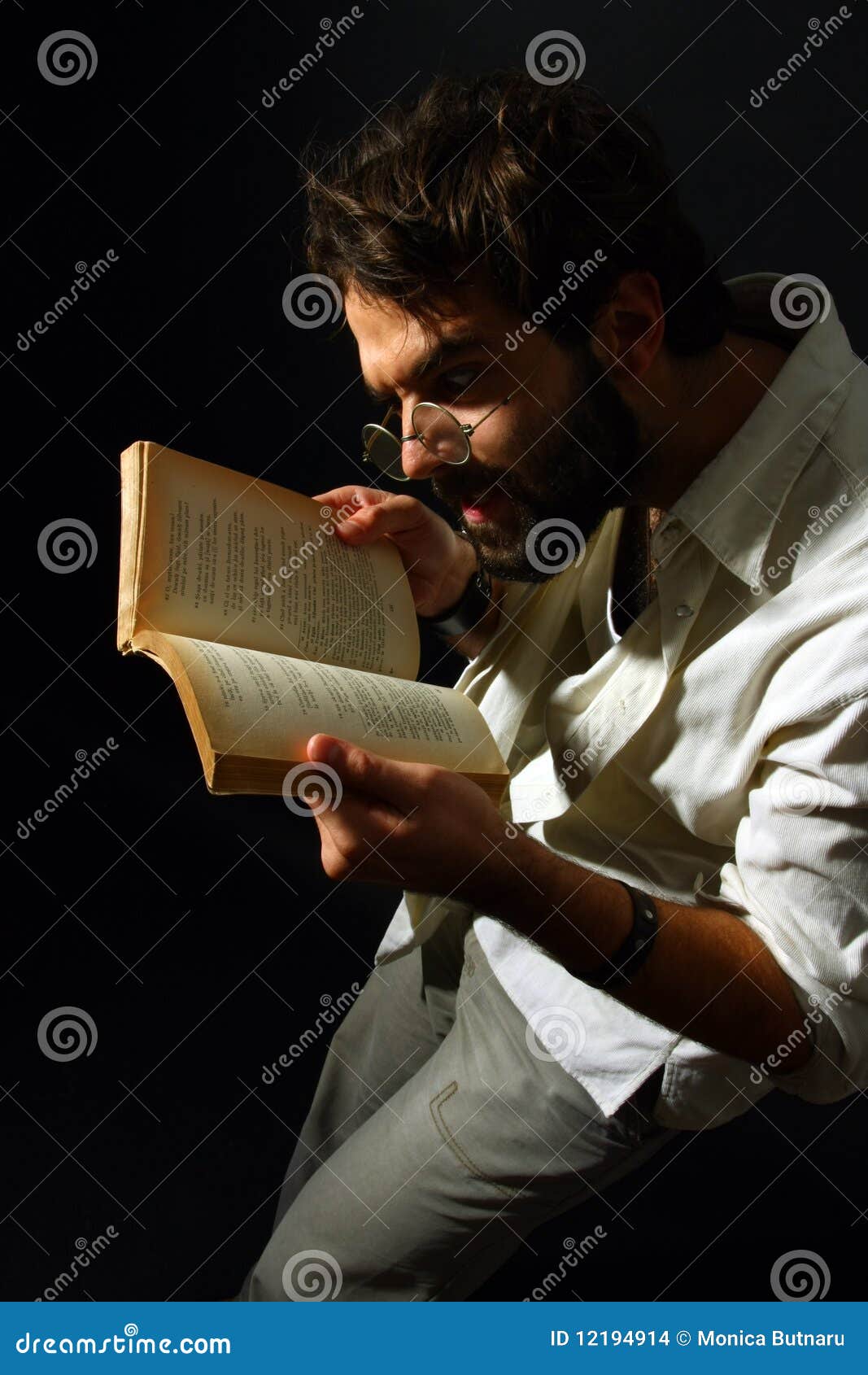 Expressive Man Reading a Book Stock Photo - Image of hold, lenses: 12194914