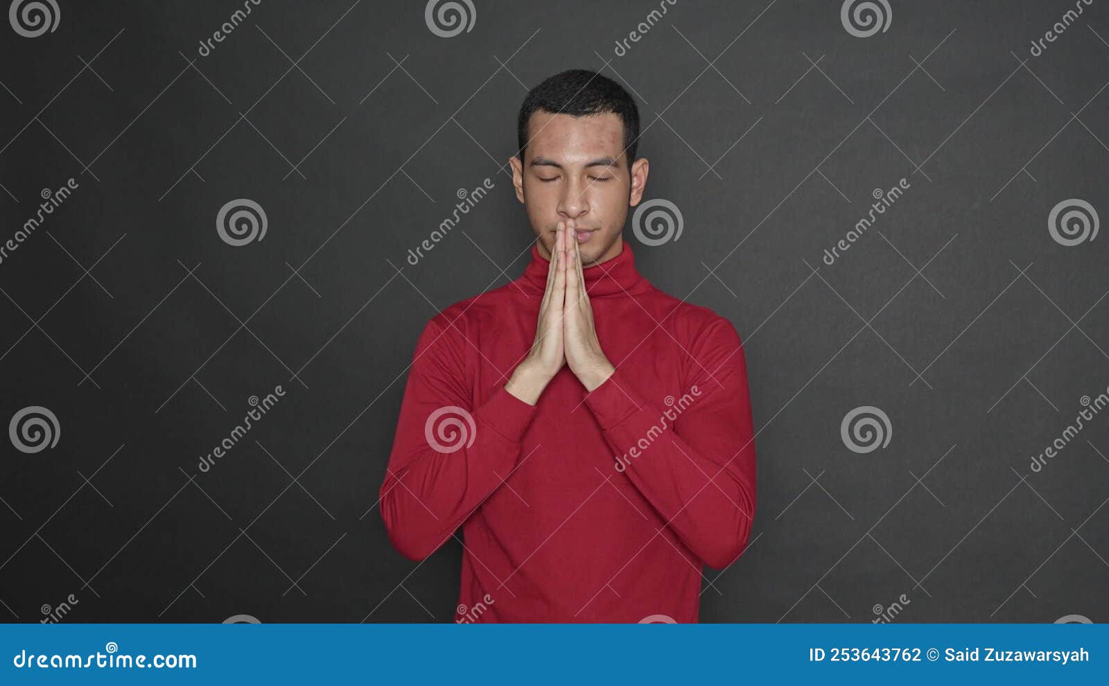 Expressive Young Man with Apologizing Gesture on a Black Background ...