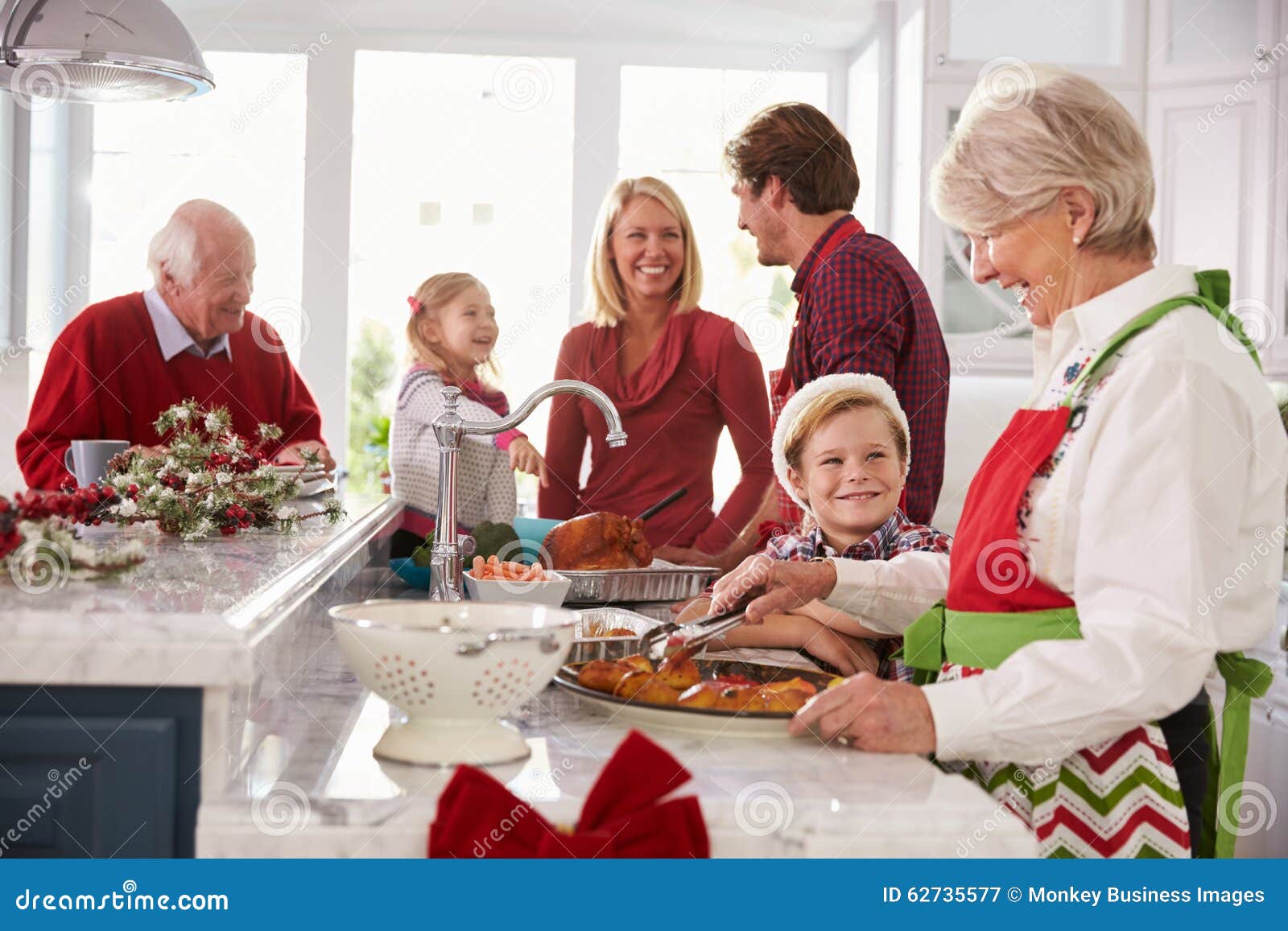 Extended Family Group Preparing Christmas Meal in Kitchen Stock Image ...