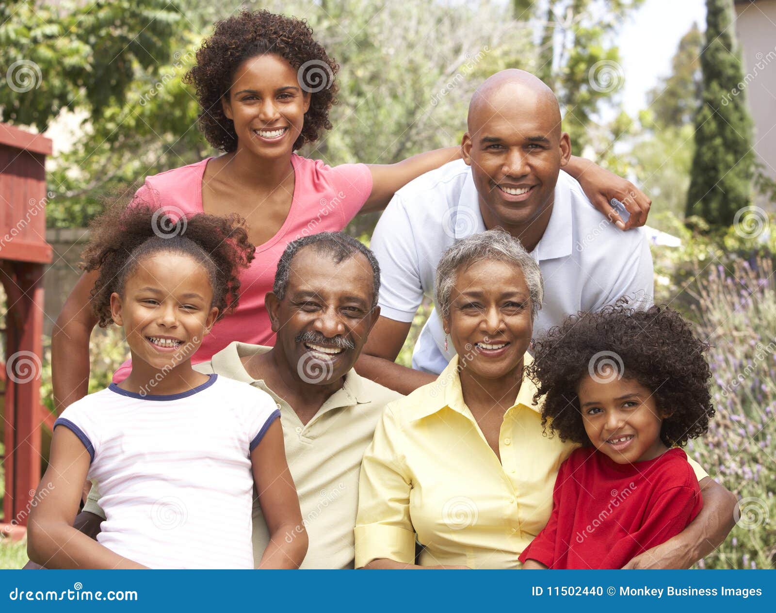 Extended Family Group Relaxing in Garden Stock Photo - Image of ...