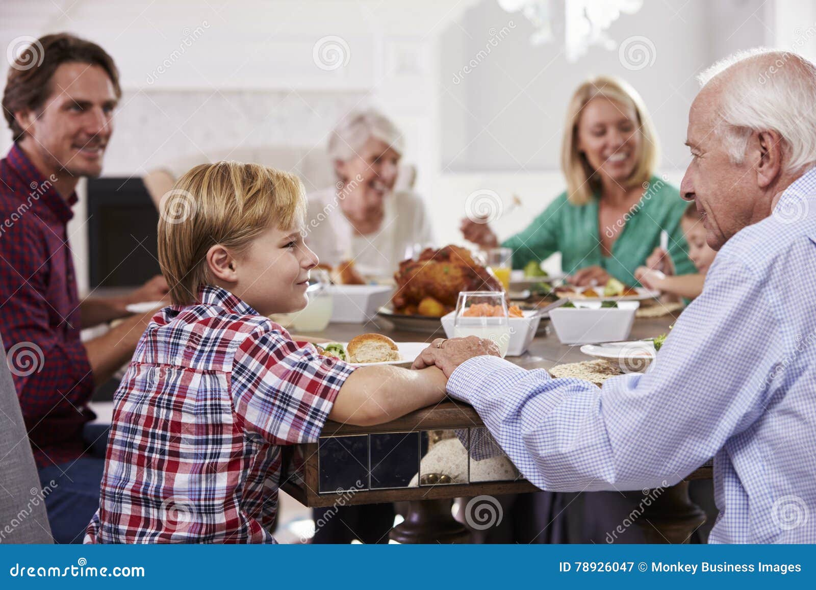 Extended Family Group Sit Around Table Eating Meal at Home Stock Image ...