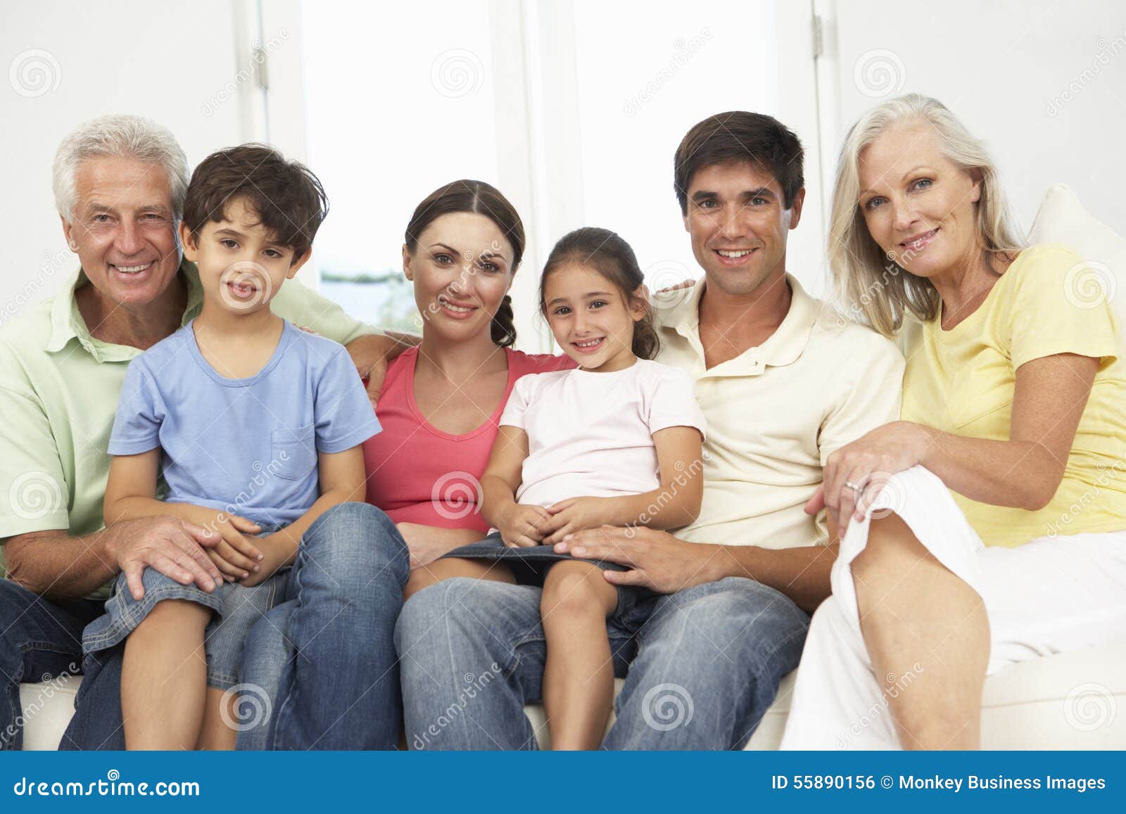 Extended Family Relaxing on Sofa at Home Together Stock Photo - Image ...