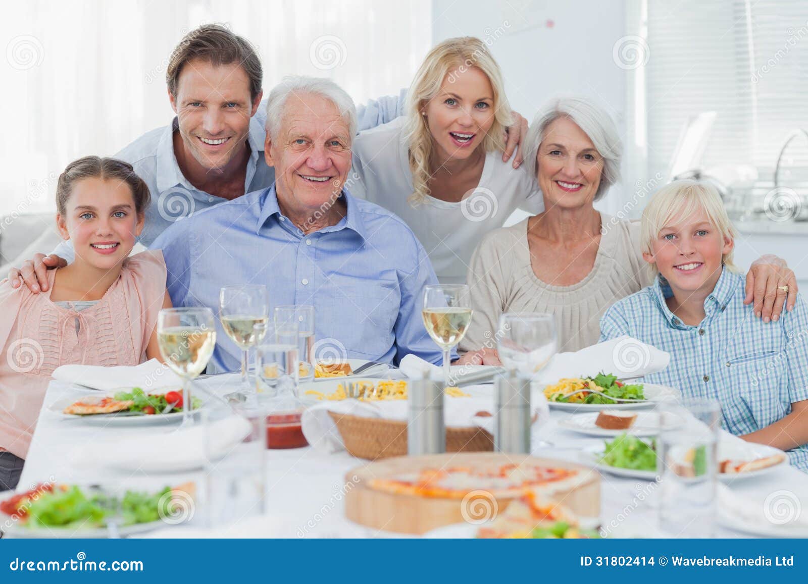 Extended Family Smiling at Dinner Family Stock Photo - Image of light ...