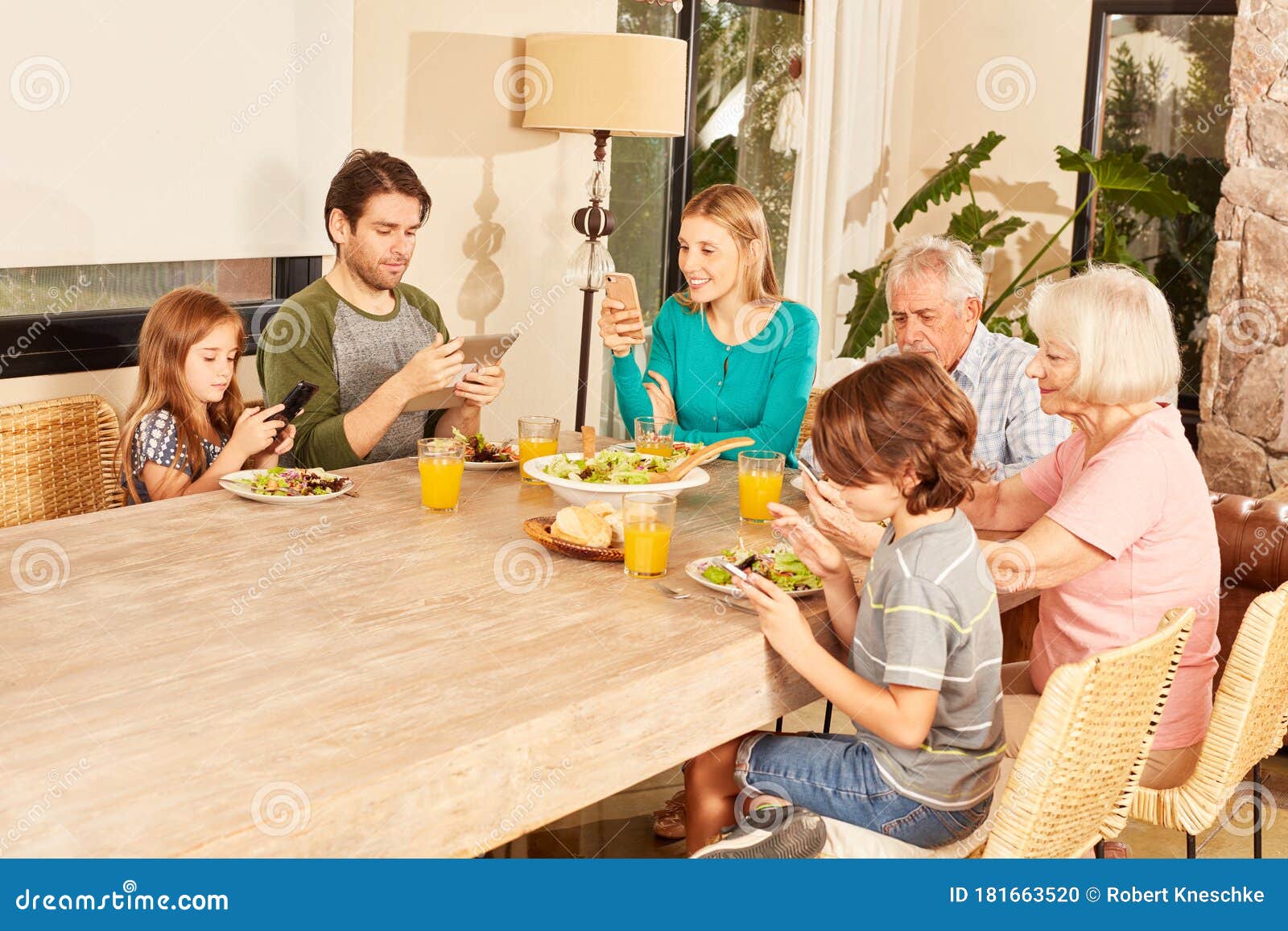 Family at the Dining Table with Tablet and Smartphones Stock Photo ... Family at the Dining Table with Tablet and Smartphones Stock Photo ...
