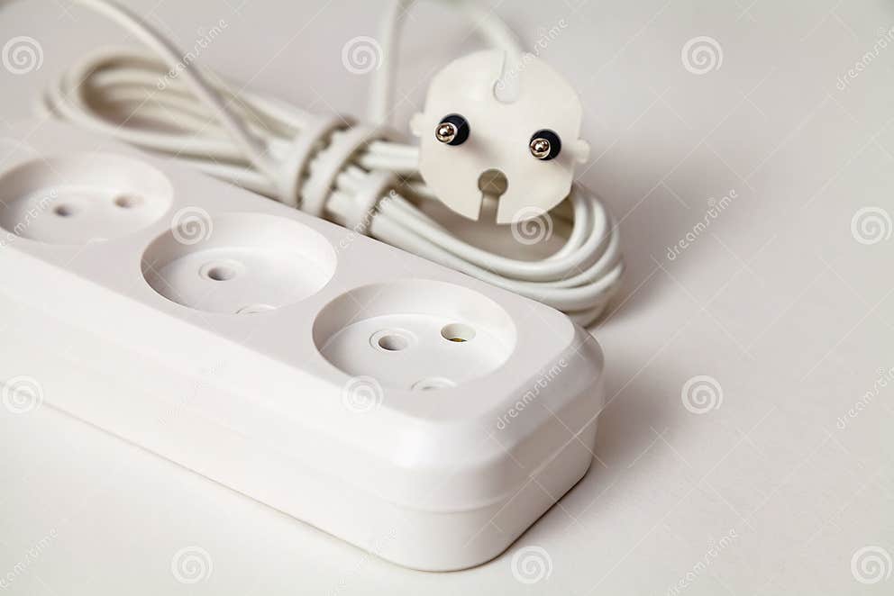 Extension Cord for Three Sockets with a Coiled Cord on a White ...