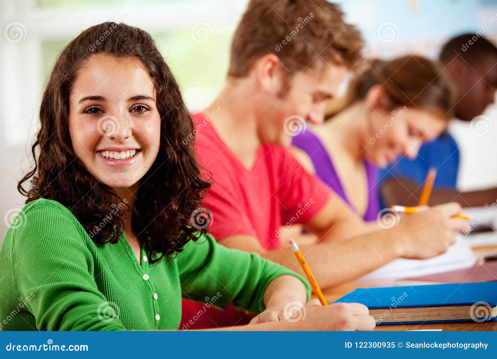Students: Row of Students Sitting at Desks Stock Image - Image of ...