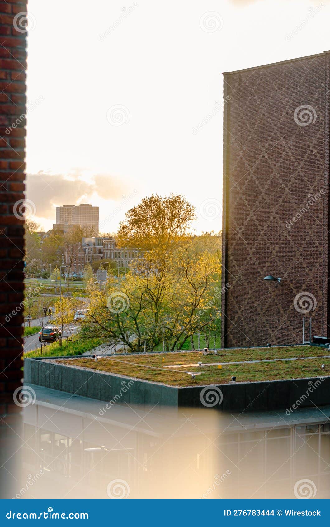 Exterior of a Brick Building with a Green Park at Sunset Stock Photo ...