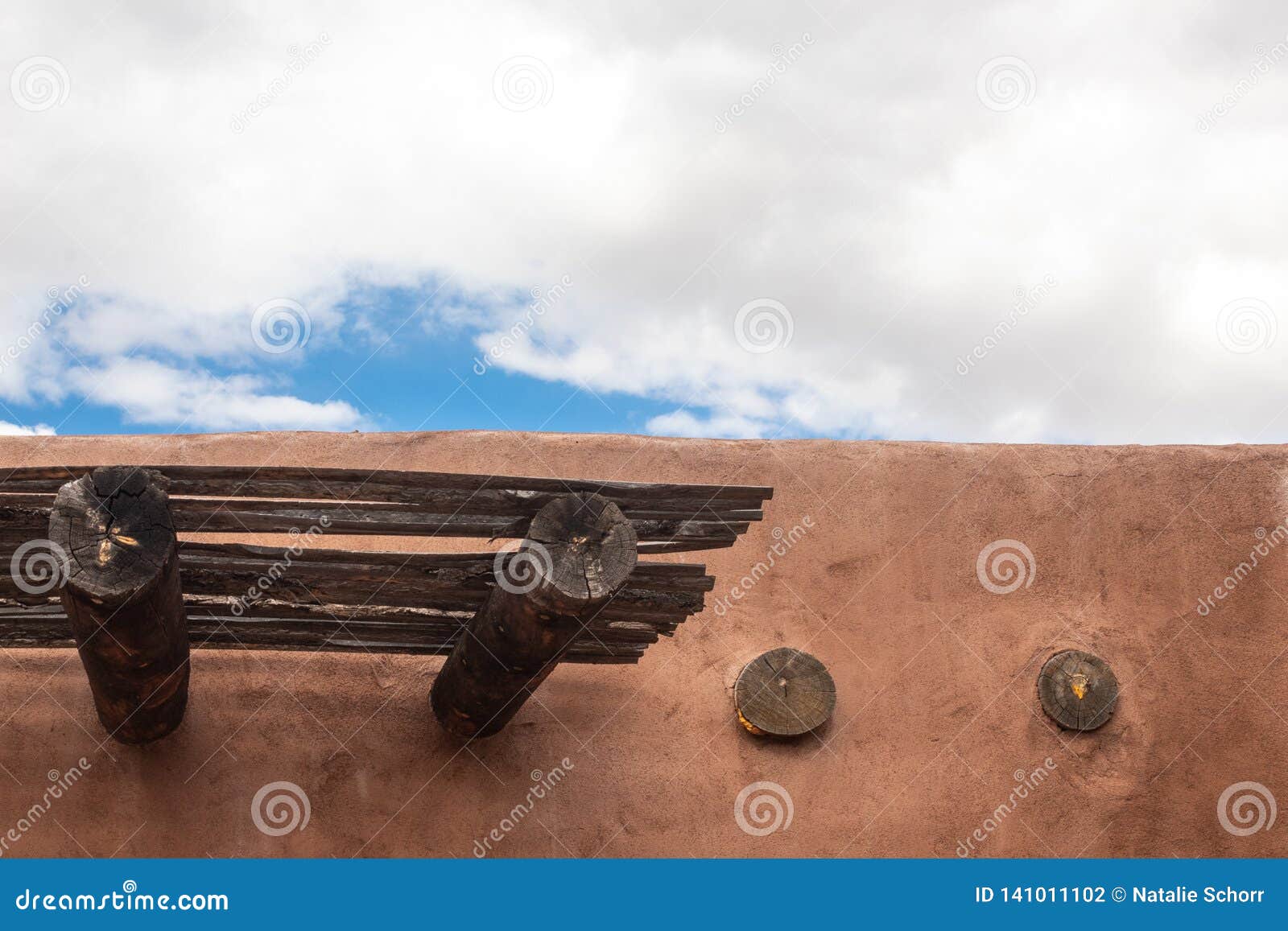 Exterior Detail of Red Adobe Building with Beams, Patch of Blue Sky ...