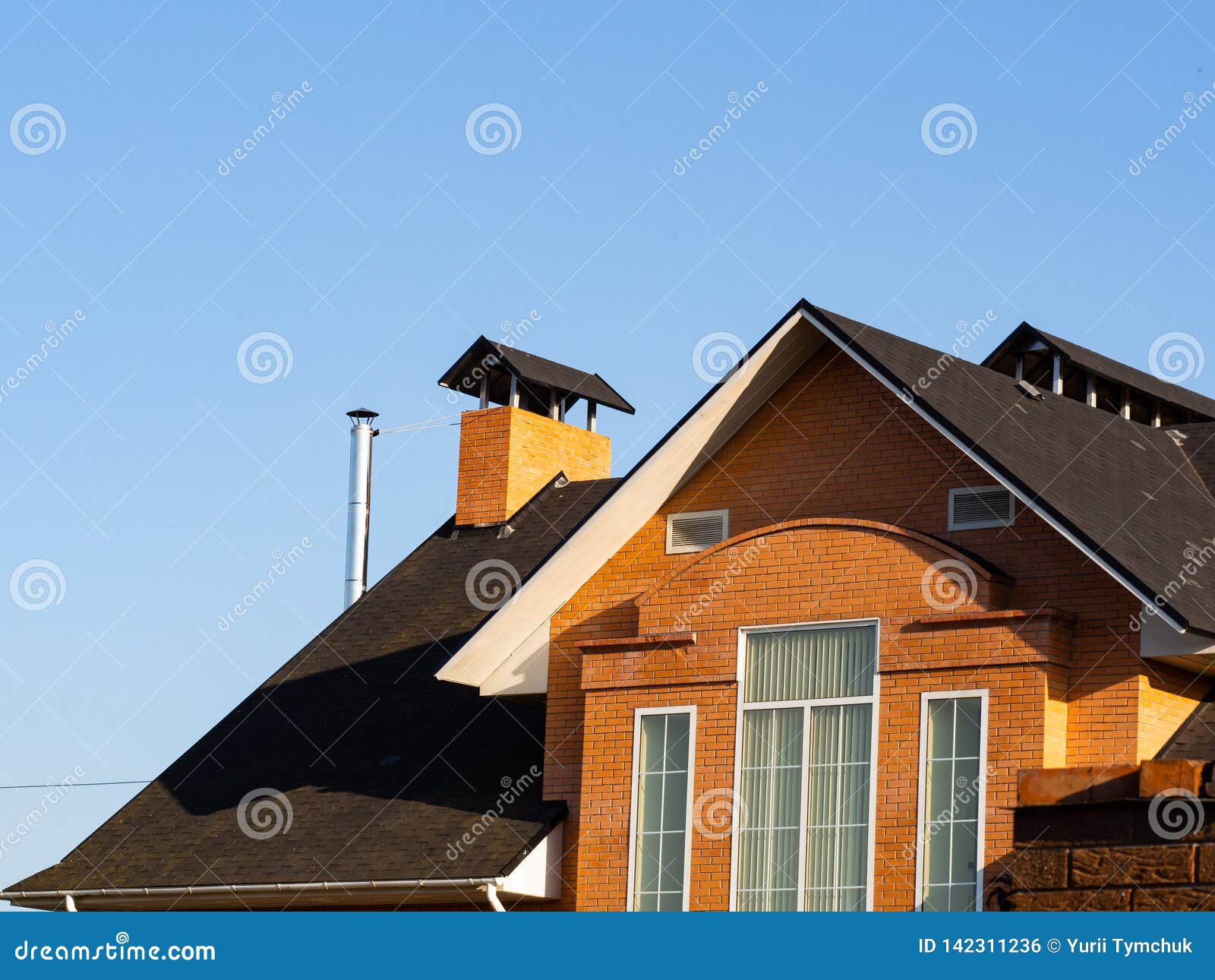 Exterior of New Brick House with Rectangular Windows and Chimney on the ...