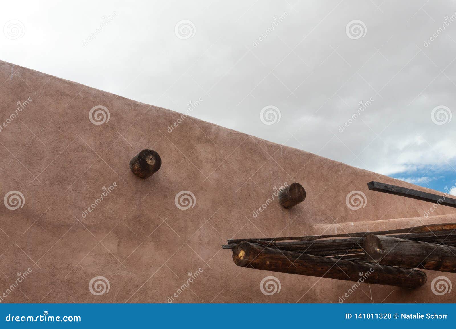 Exterior Red Adobe Building with Beams, Cloudy Sky Stock Photo - Image ...