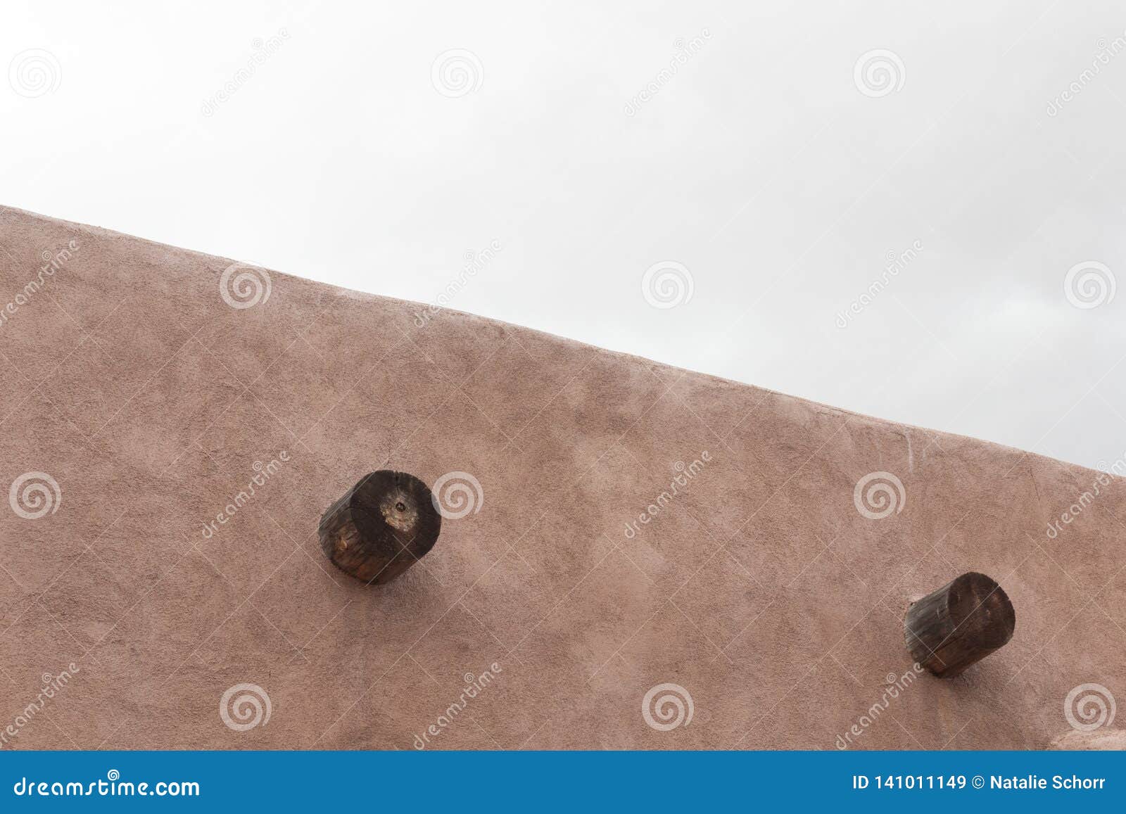 Exterior of Red Adobe Building, Two Exposed Vigas, Grey Cloudy Skies ...