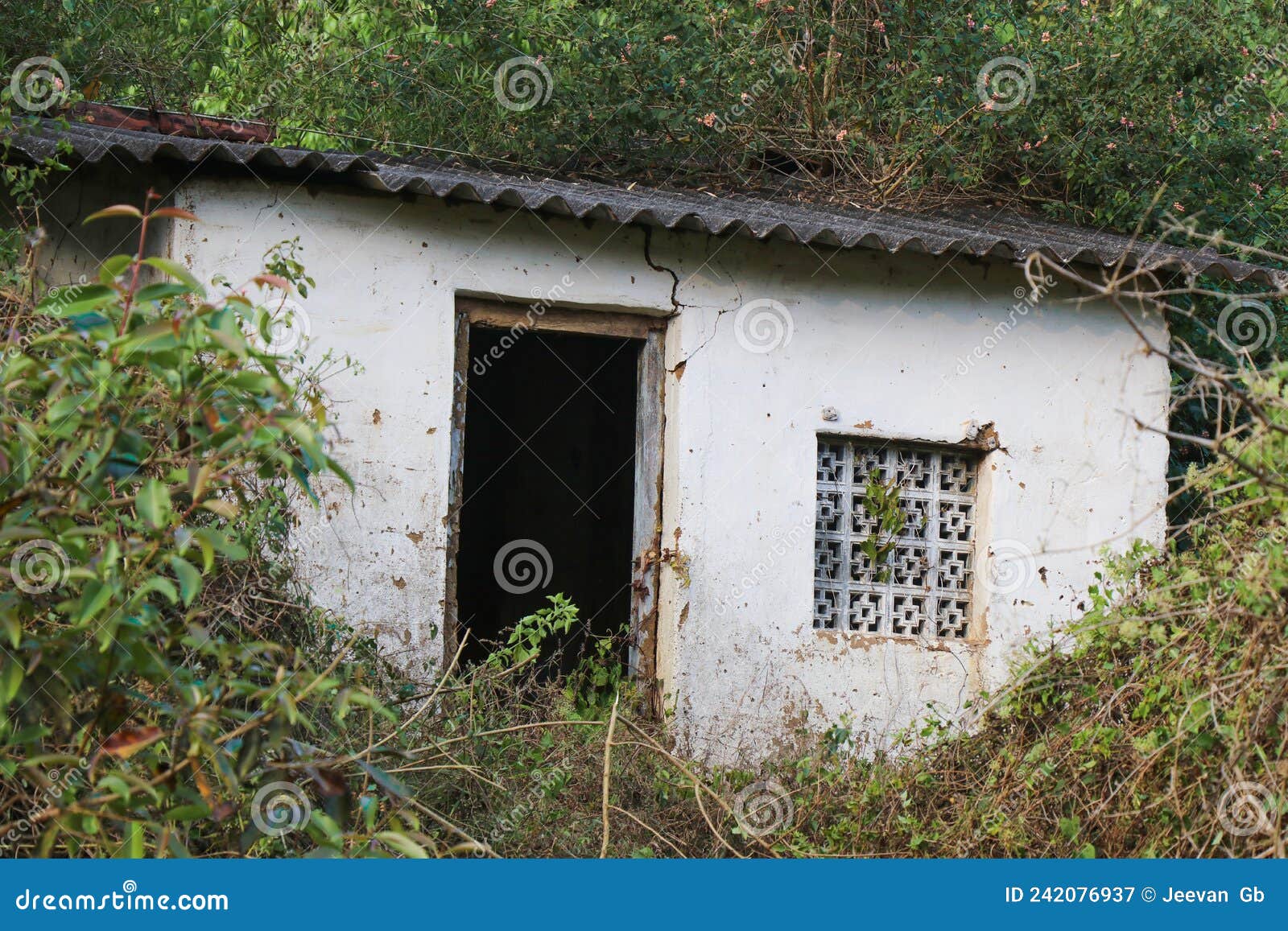 The Exterior of a Small Abandoned House without Doors Surrounded by ...