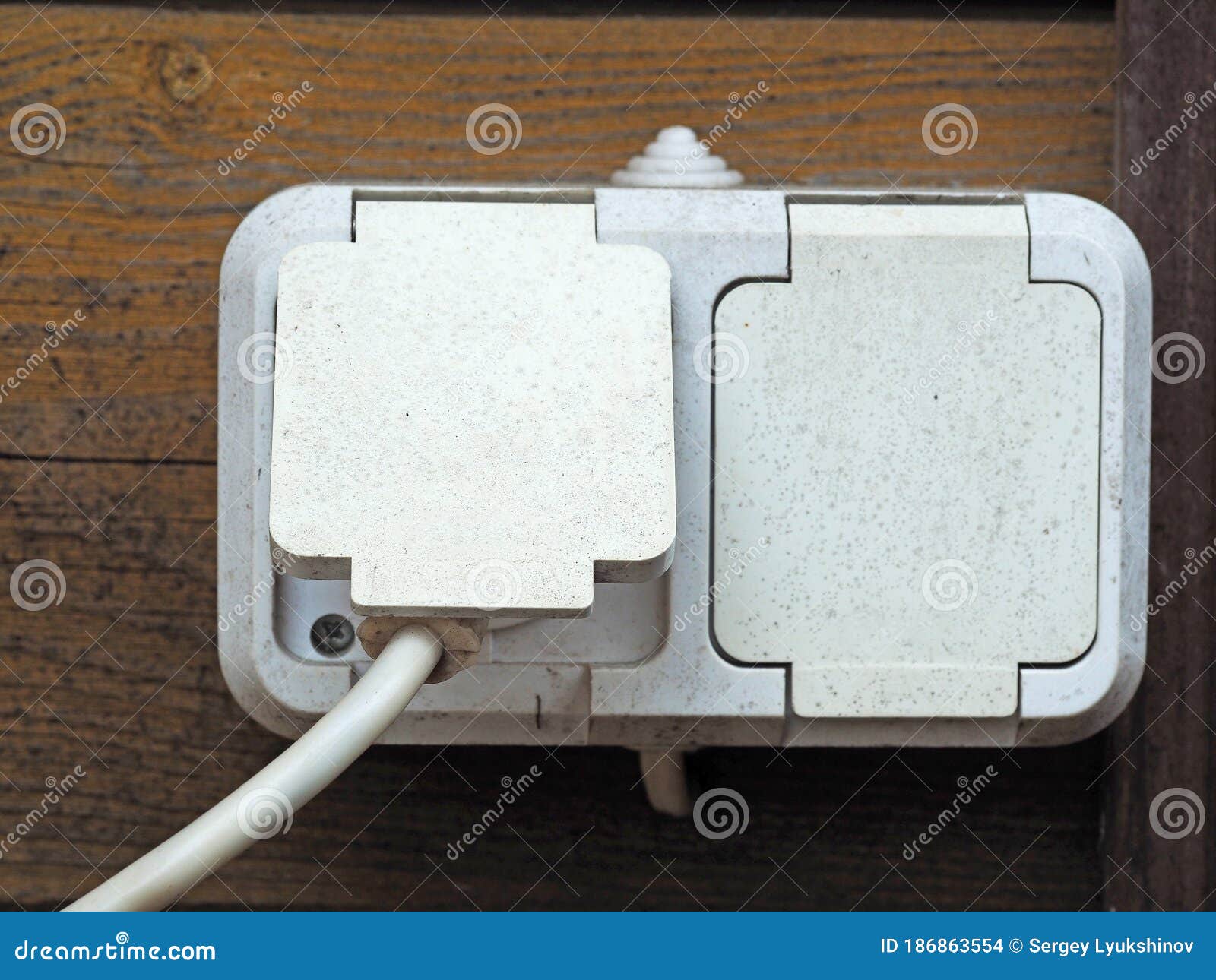 External Electrical Outlet on the Wooden Wall of the House. Plastic ...