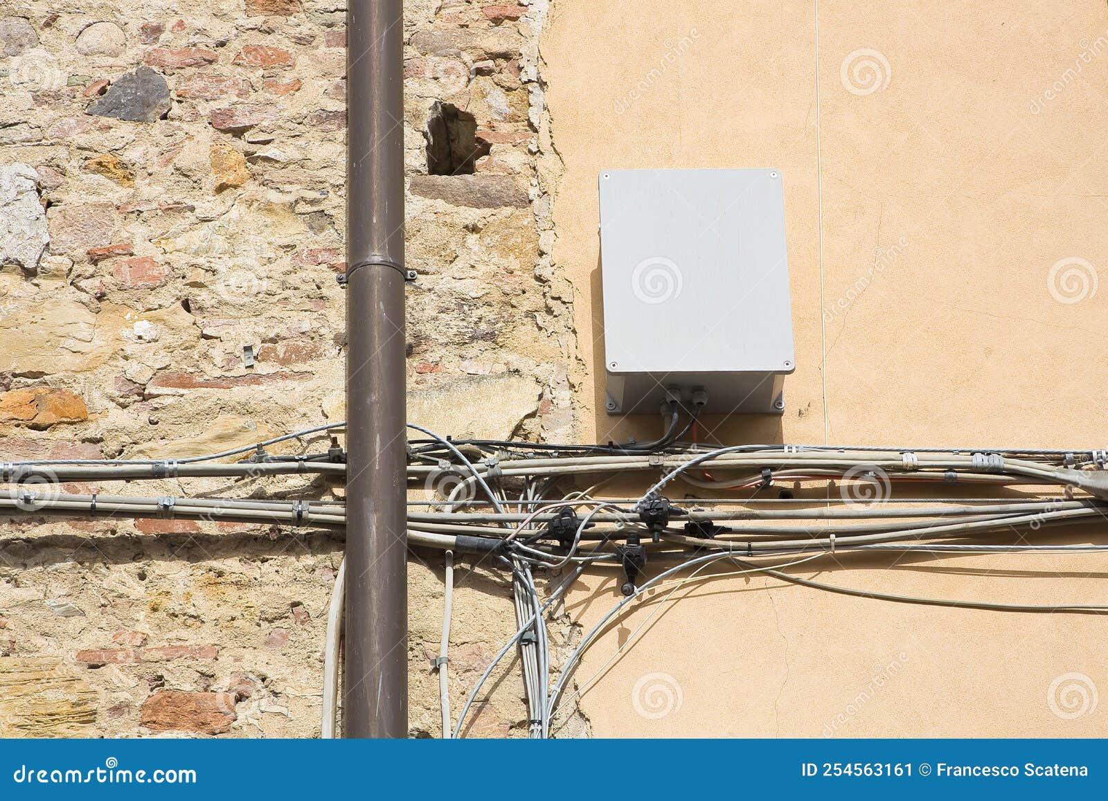 External Telephone and Electric Cables Against an Old Brick Wall Stock ...