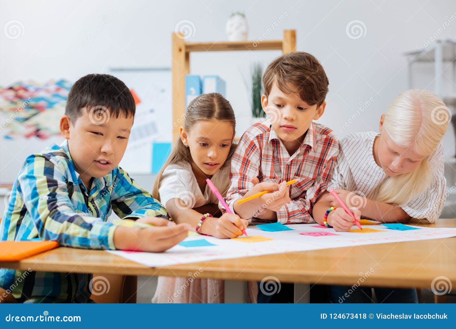 Concentrated Kids Drawing a Bright Poster in a Class Stock Photo ...