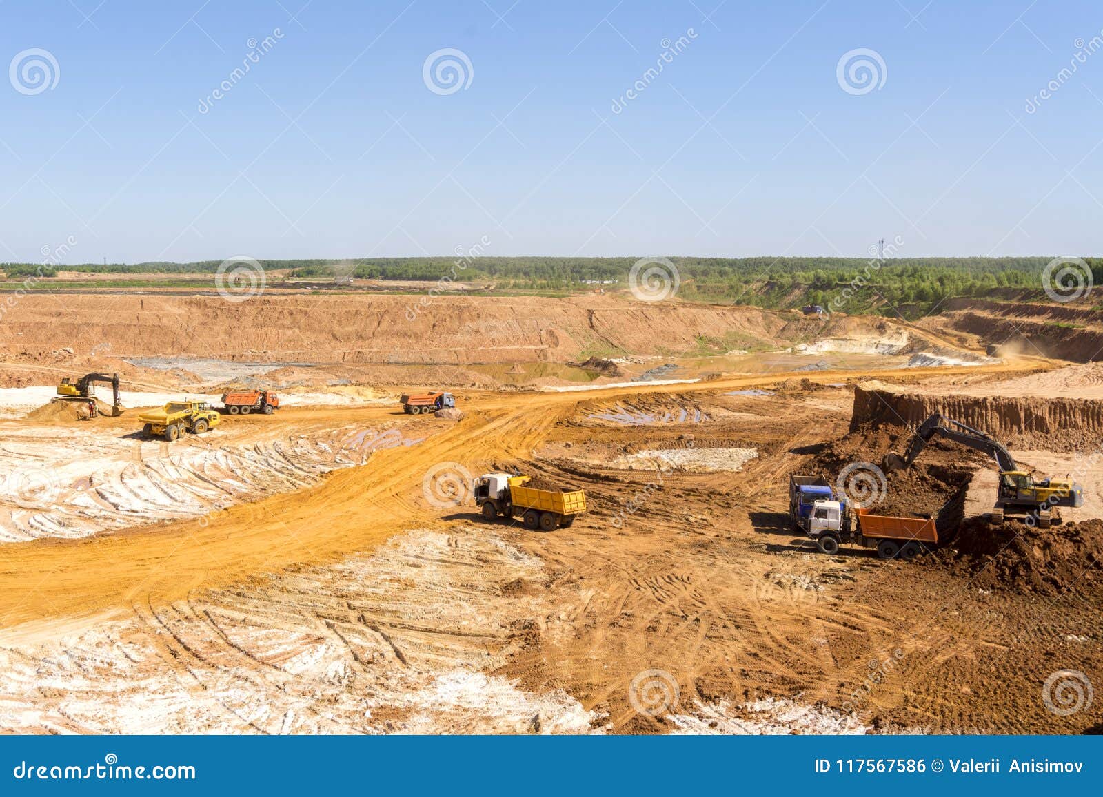 Extraction of Sand in the Quarry. Backhoe Loading Sand into Dump Trucks ...
