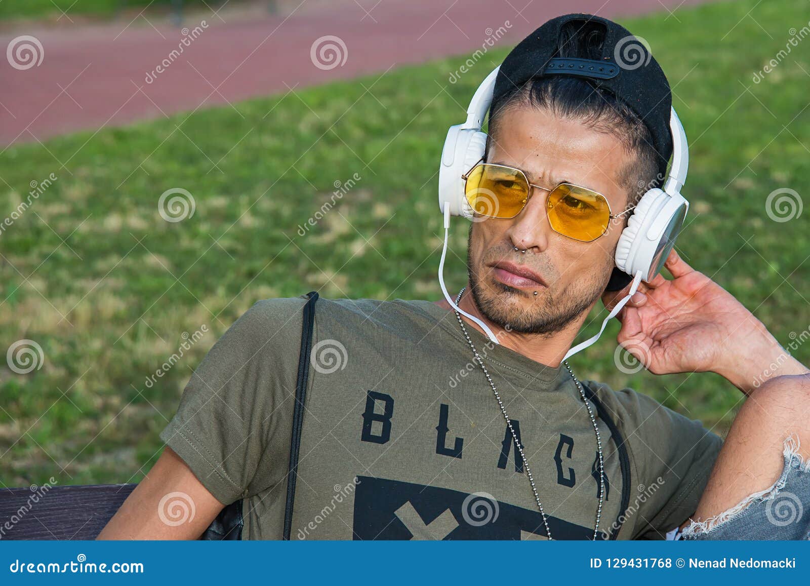 Extravagant Hipster Male Model With Sunglasses Headphones And A Black